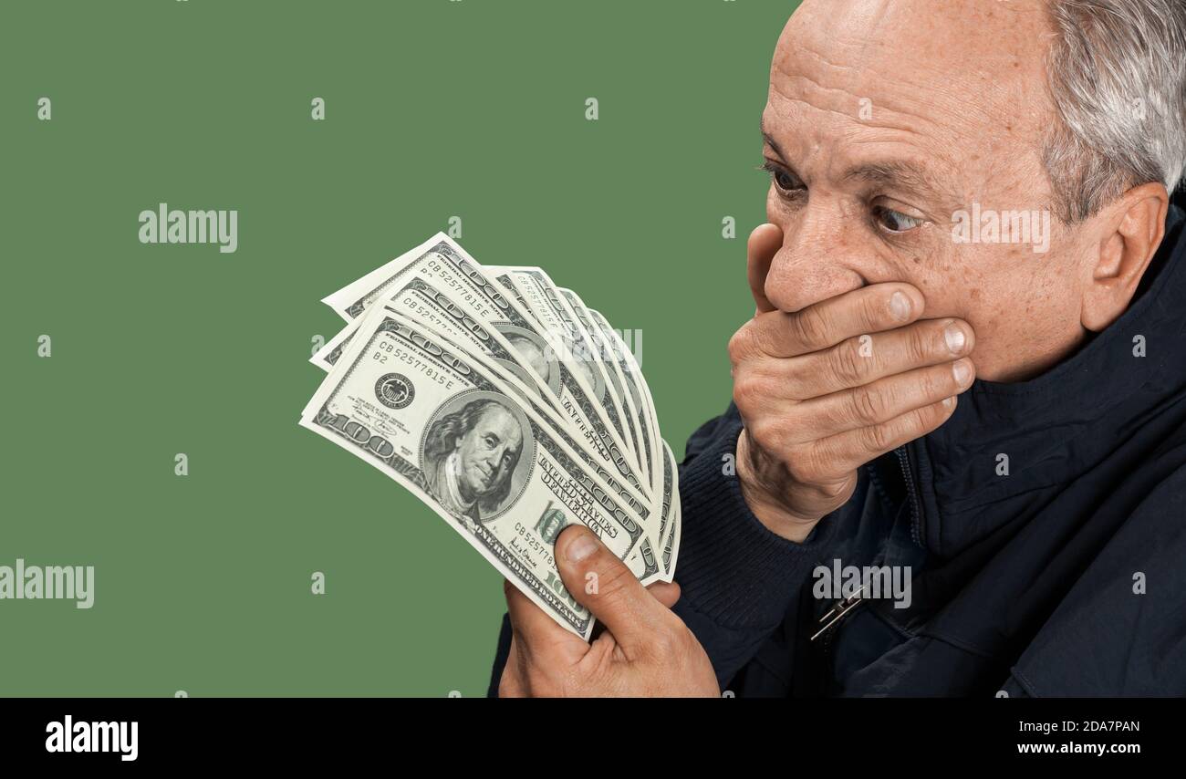 Senior gentleman holding a stack of money. Portrait of an excited old ...
