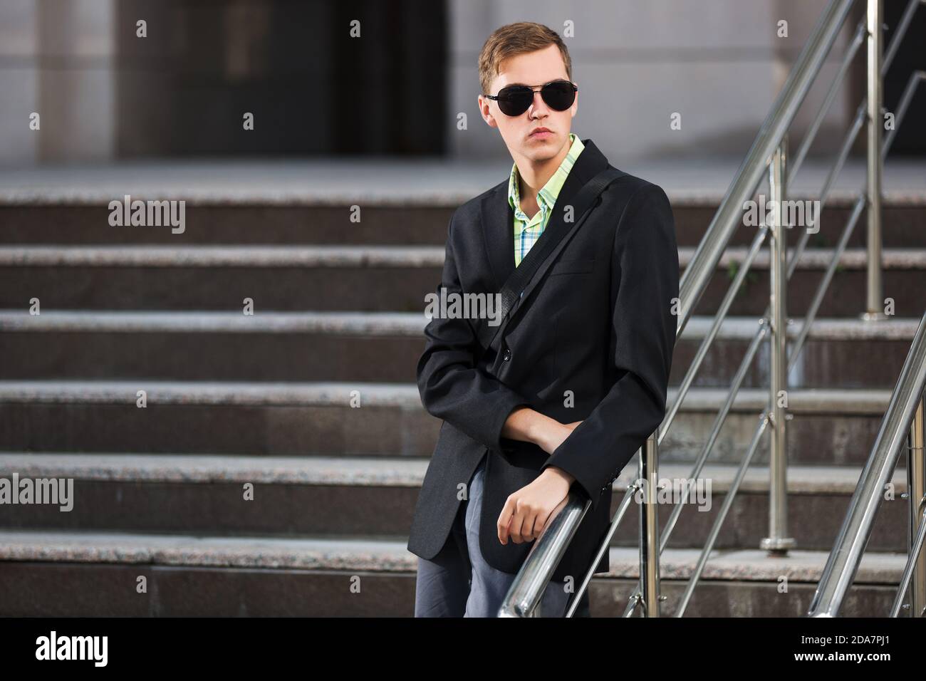 Young handsome business man leaning on railing Stylish fashion male ...