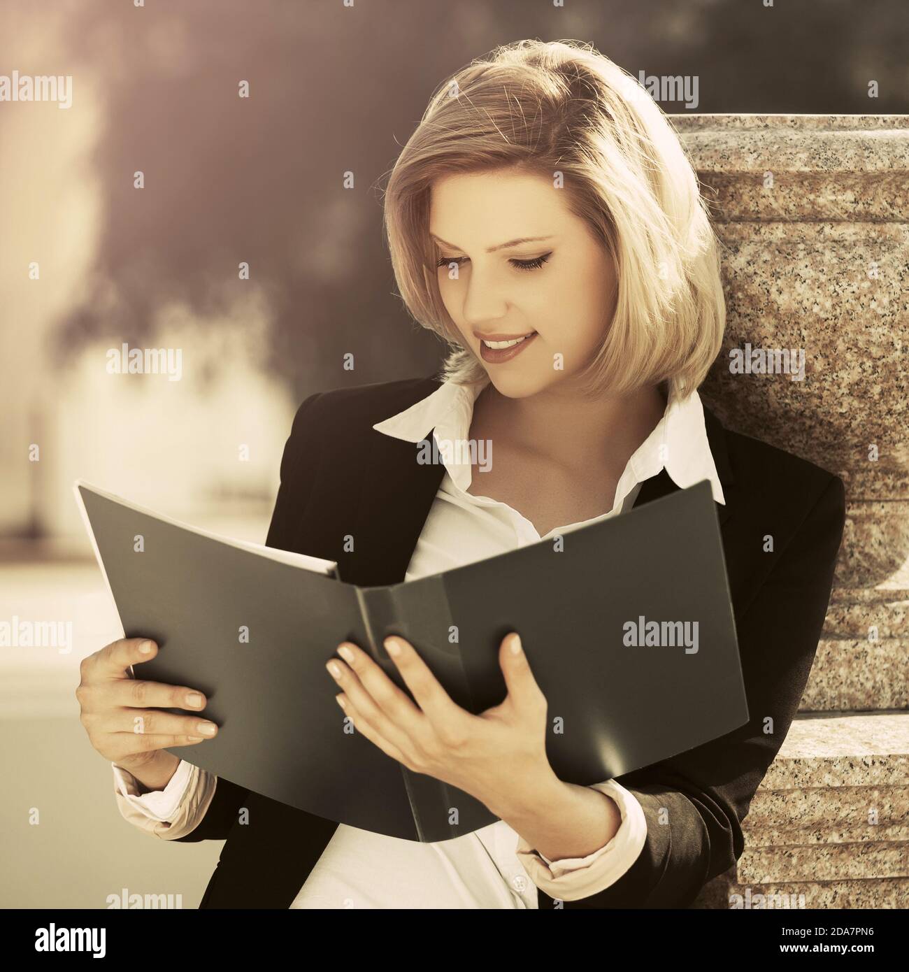 Happy young business woman with a file folder Stylish fashion model in ...