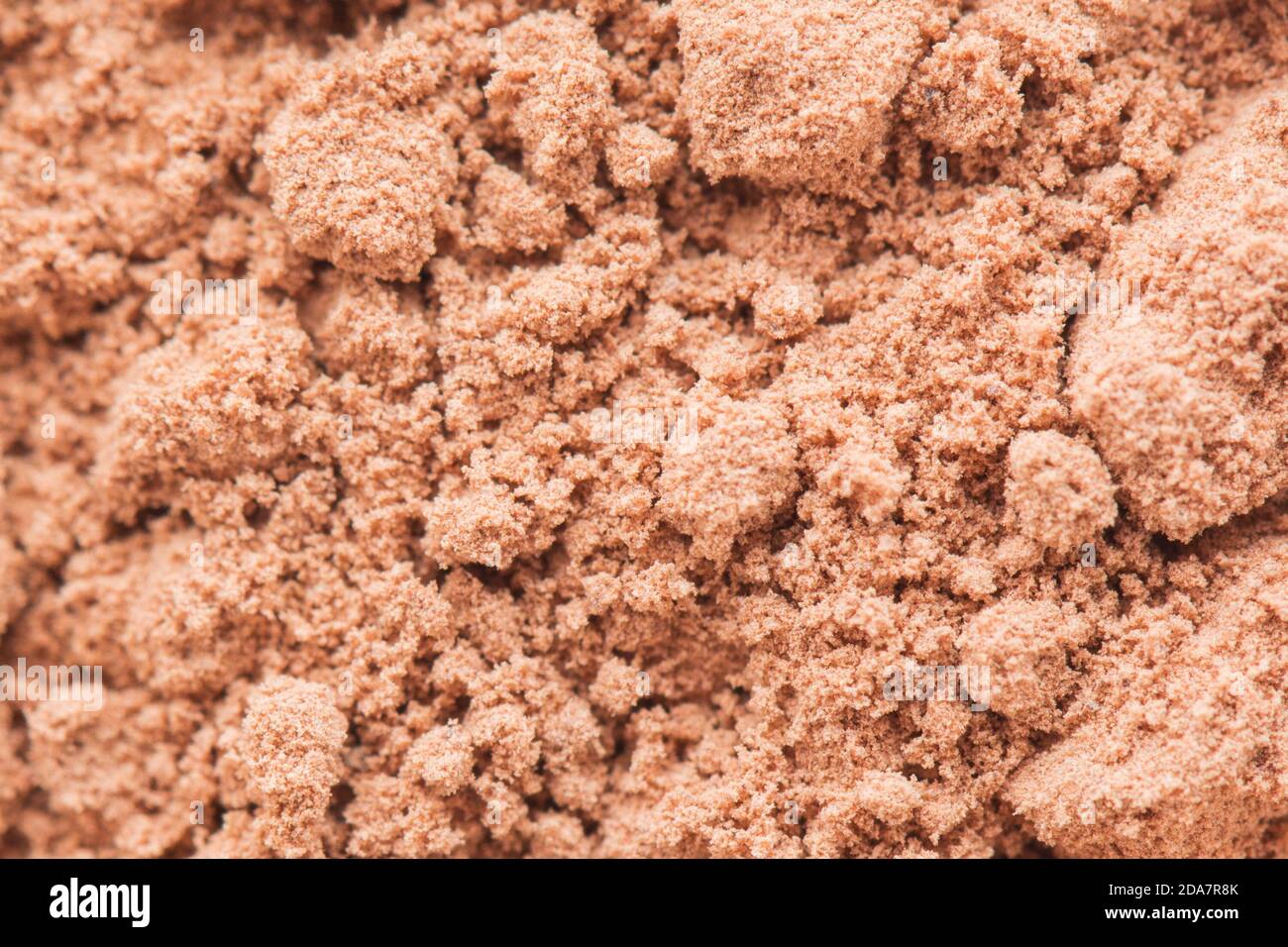 Defocused abstract rough ground red soil texture or dry cocoa powder ...