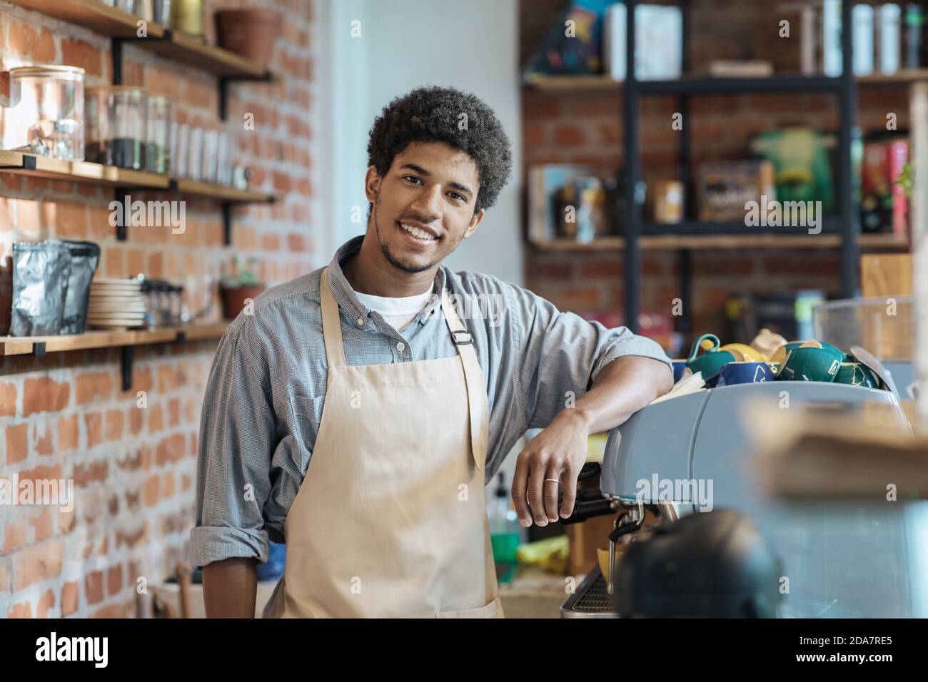 Coffee shop man owner working in apron, open after lockdown quarantine ...