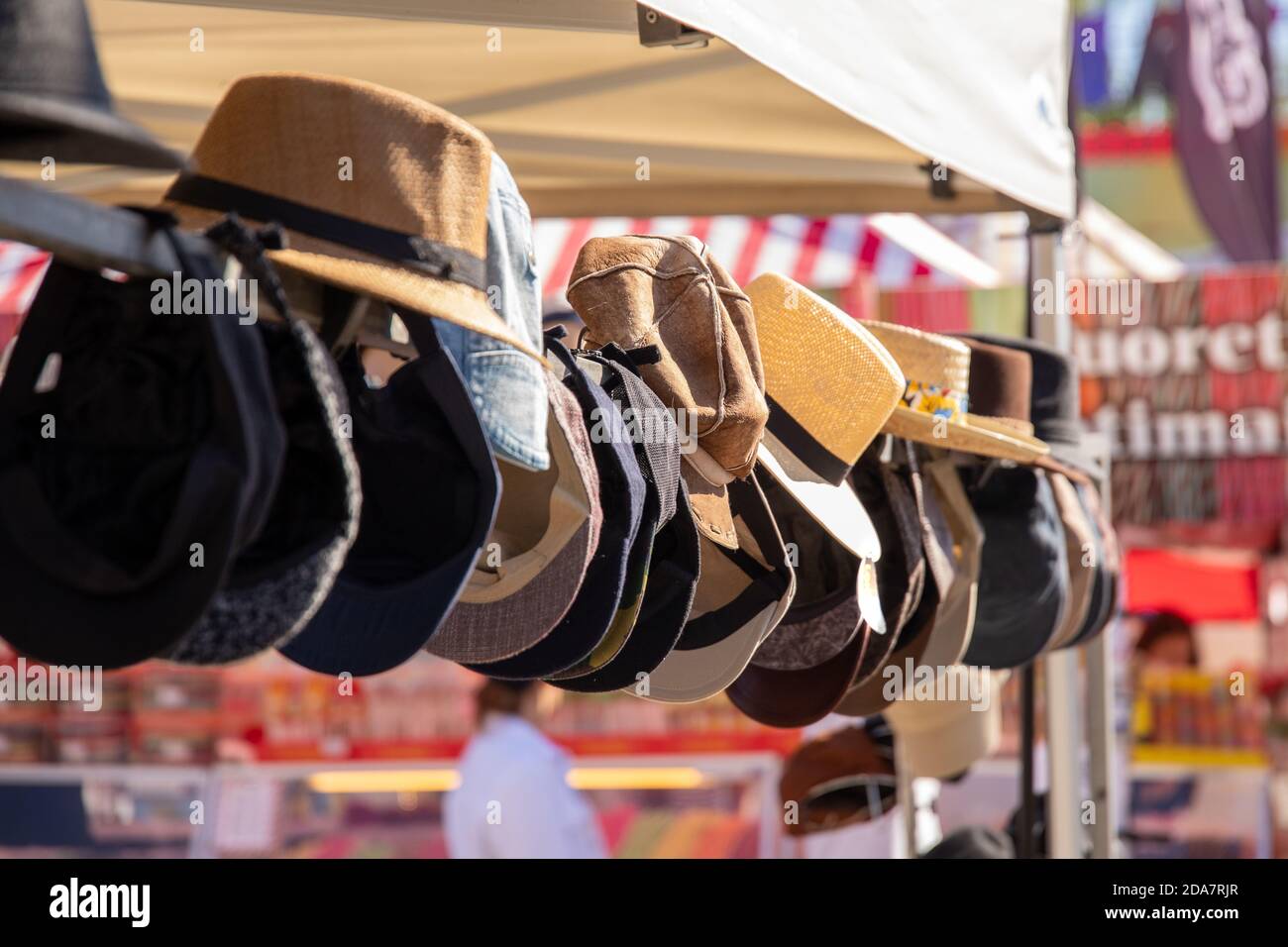 Groups of colored hats on sale hung from a pole Stock Photo - Alamy