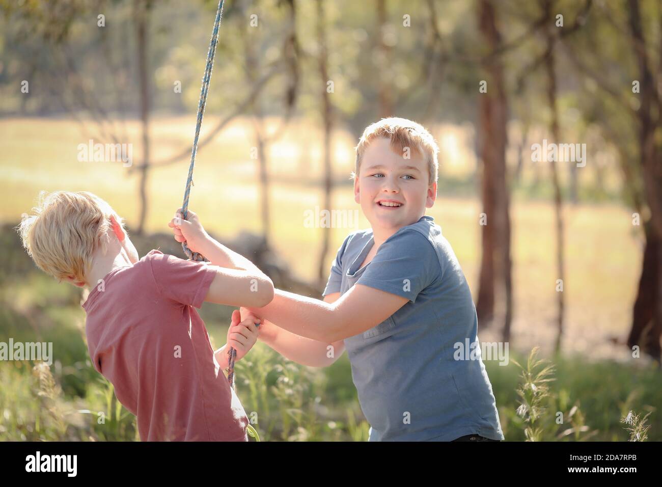 Playful children playing and pulling the rope Stock Photo - Alamy