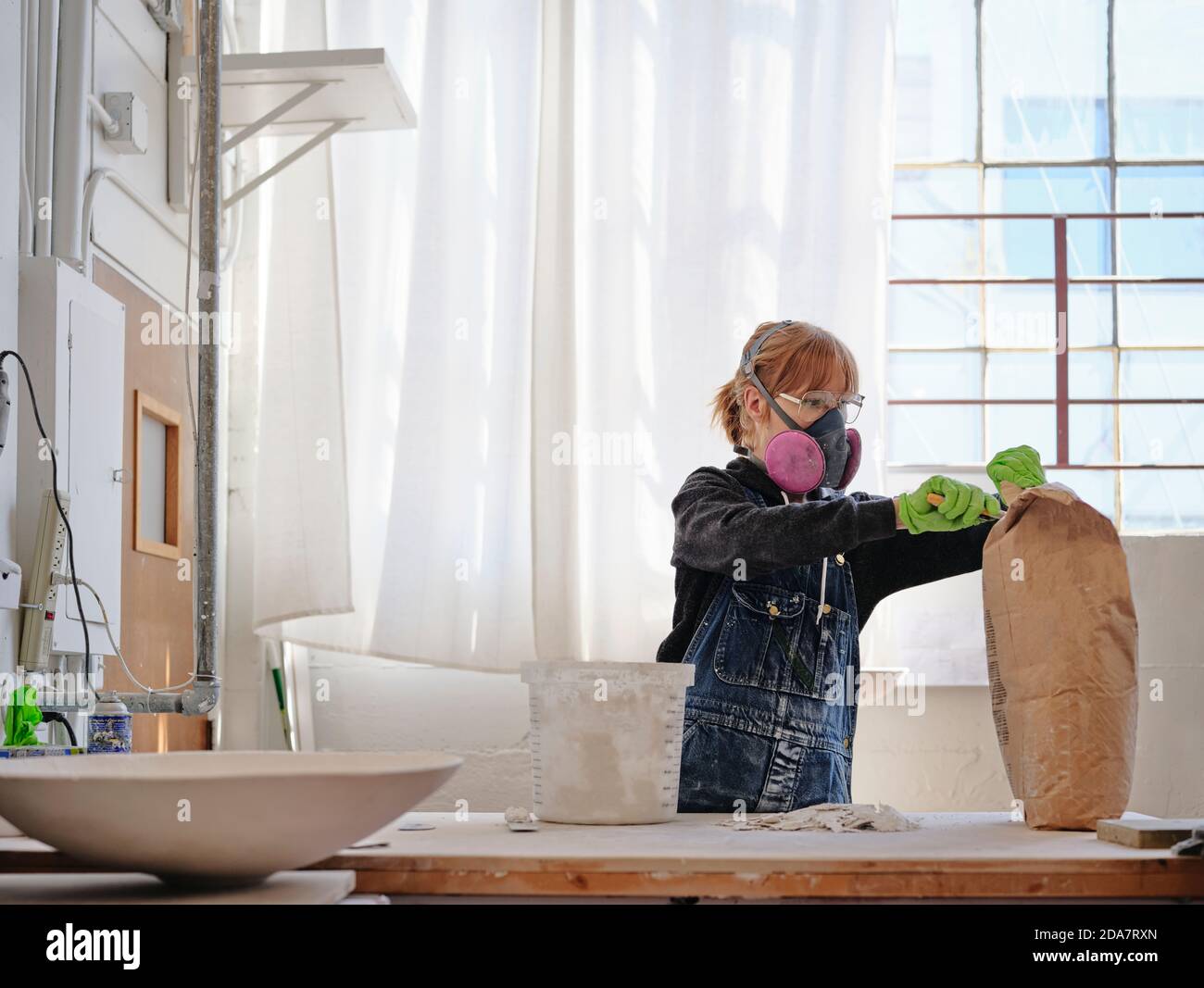 Professional female sculptor mixing plaster in her studio Stock Photo ...
