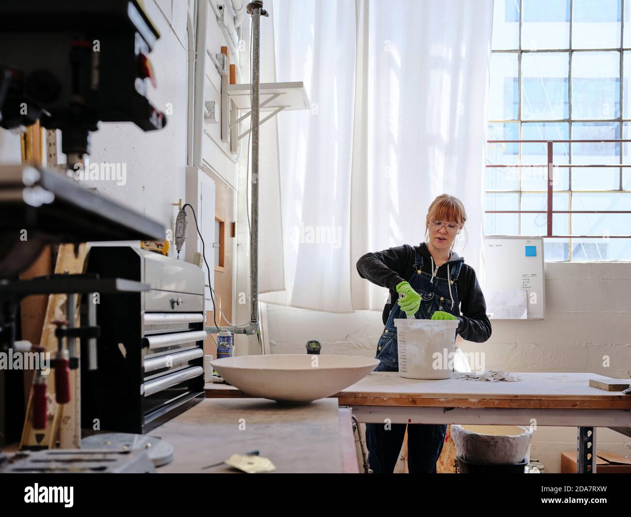 Professional female sculptor mixing plaster in her studio Stock Photo ...