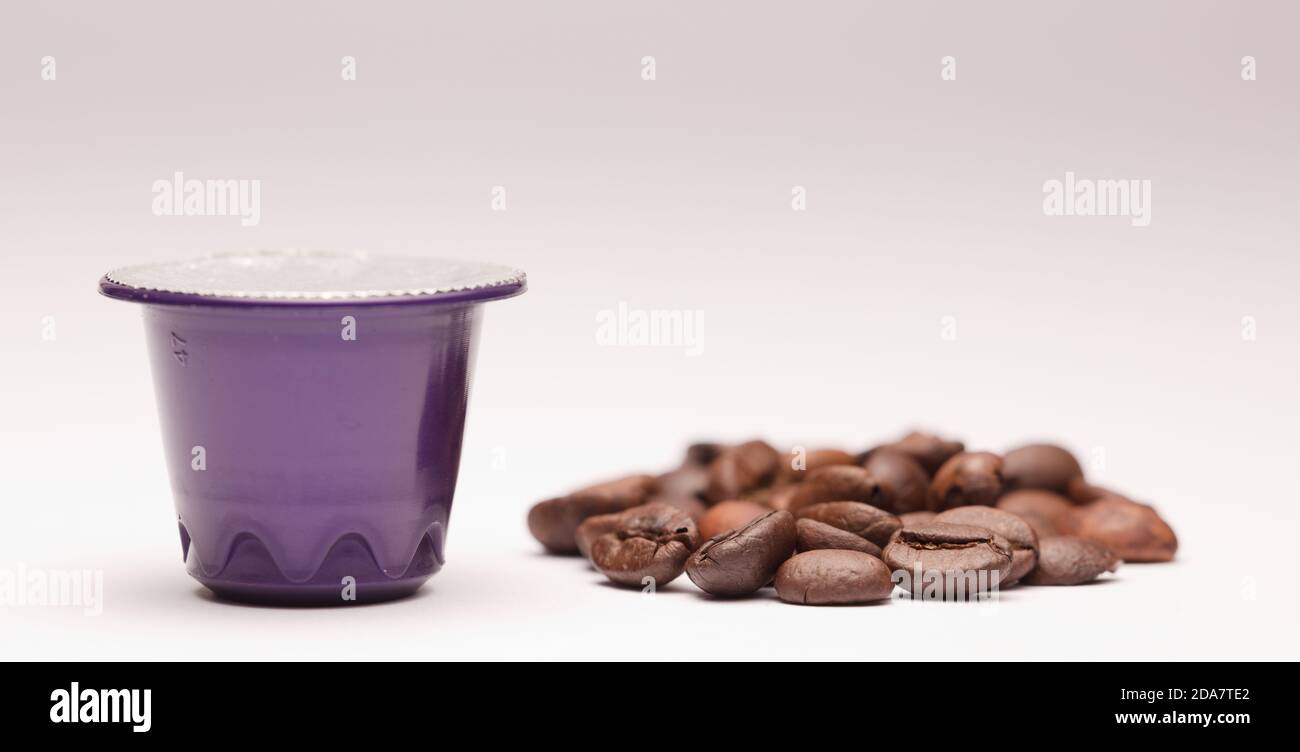 purple coffee capsule, with coffee beans, white background Stock Photo ...
