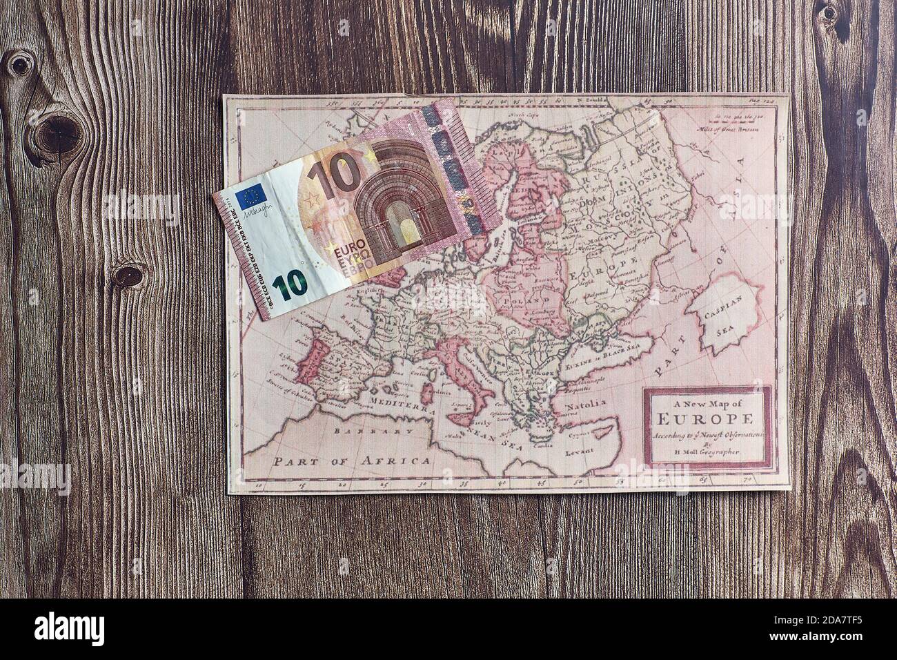 Top view closeup of 10 euro banknote placed on an ancient map on a ...