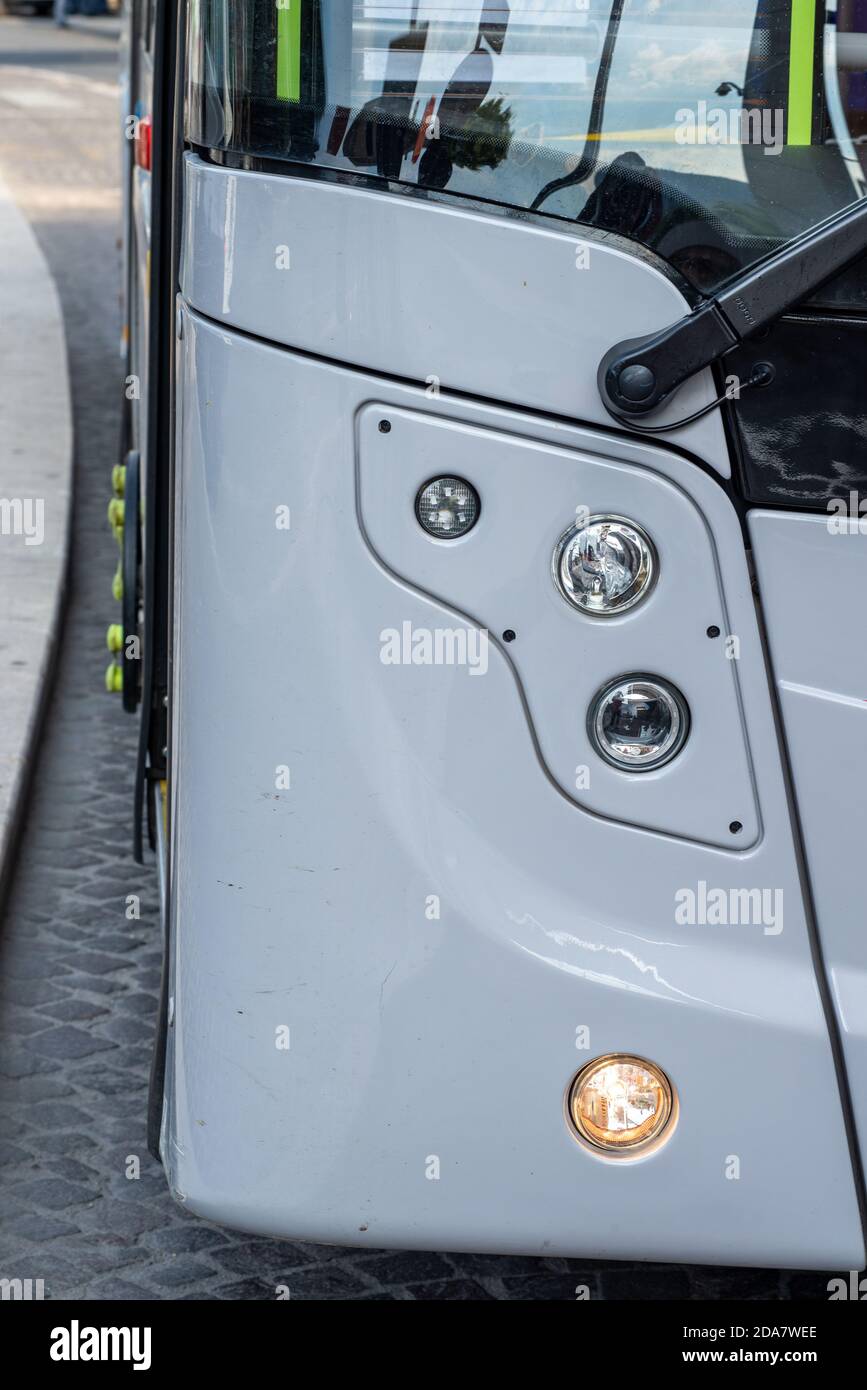 detail of headlight of an urban bus at the station Stock Photo - Alamy