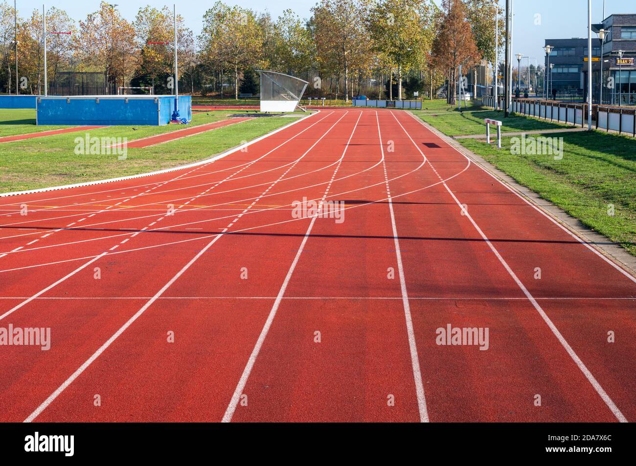 Empry red running lane on outdoor school stadium Stock Photo - Alamy
