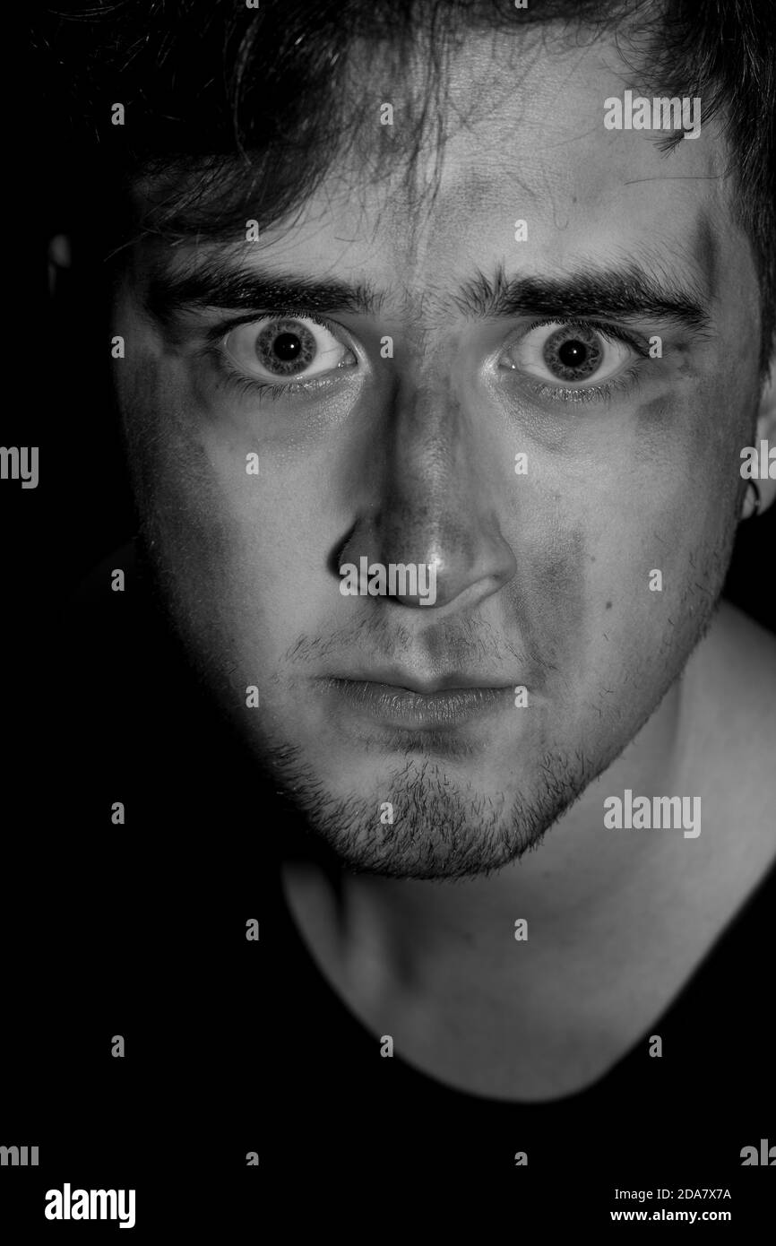 Dirtied man staring directly into the camera Stock Photo - Alamy