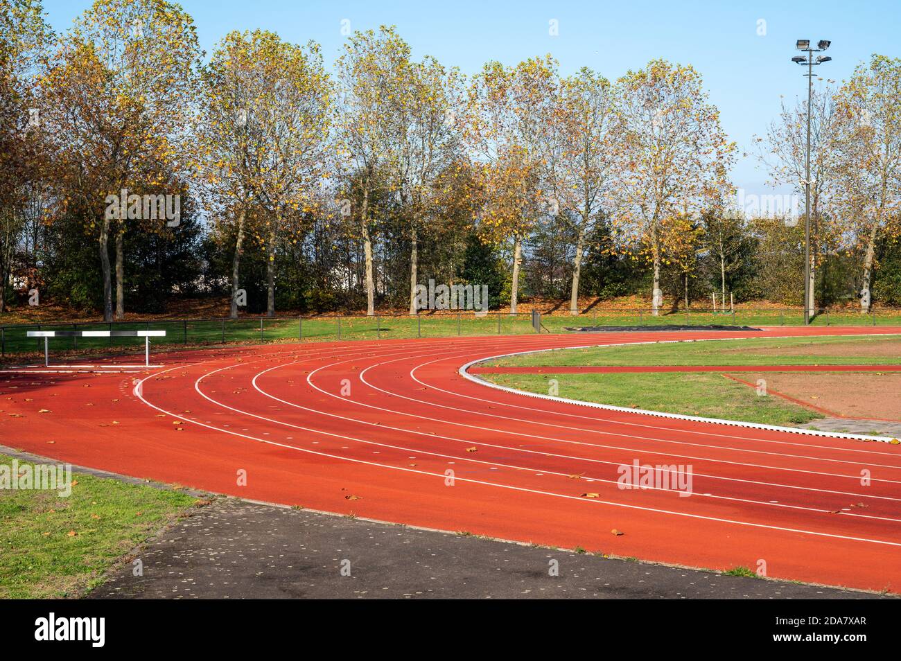 Empry red running lane on outdoor school stadium Stock Photo - Alamy