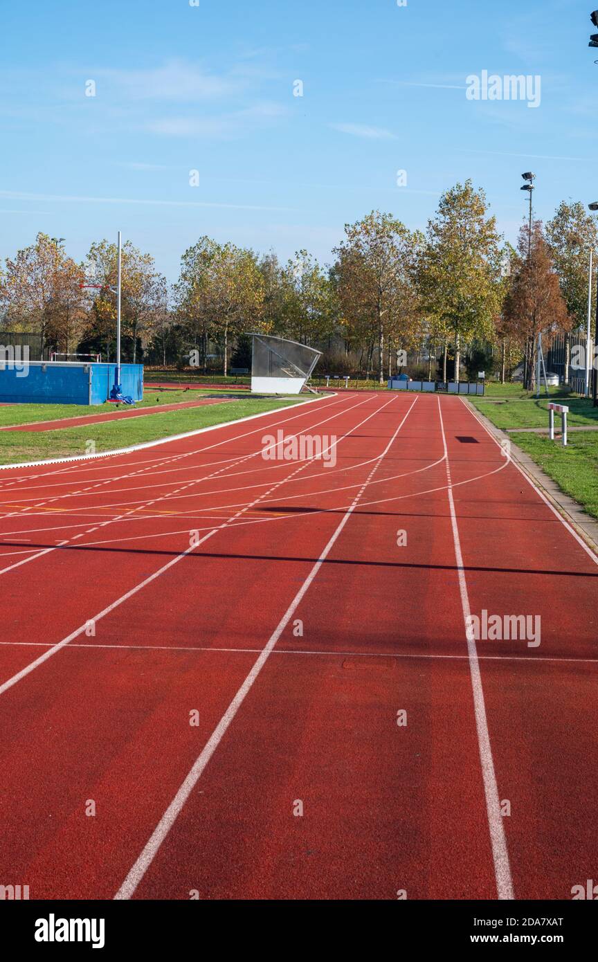 Empry red running lane on outdoor school stadium Stock Photo - Alamy
