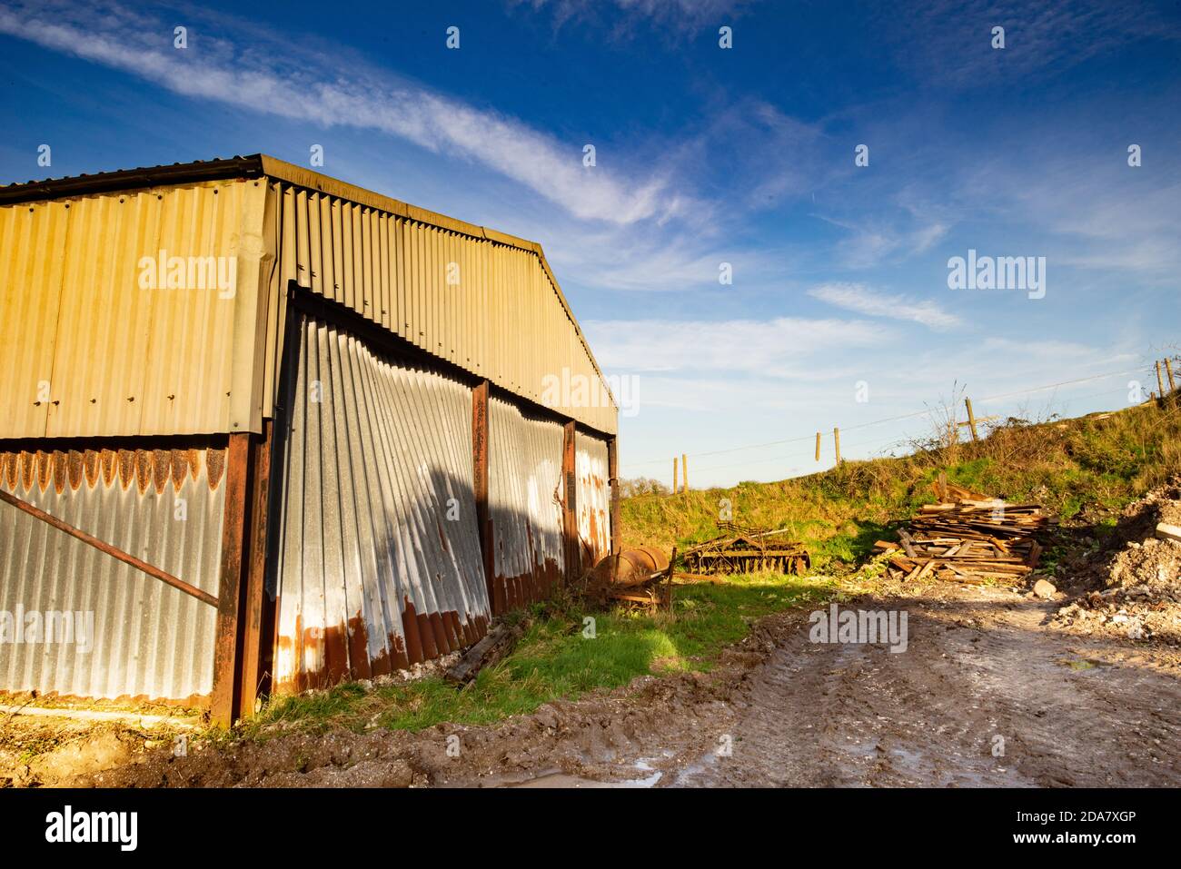 Corrugated barn with rust and damage in Rackham, West Sussex, England ...