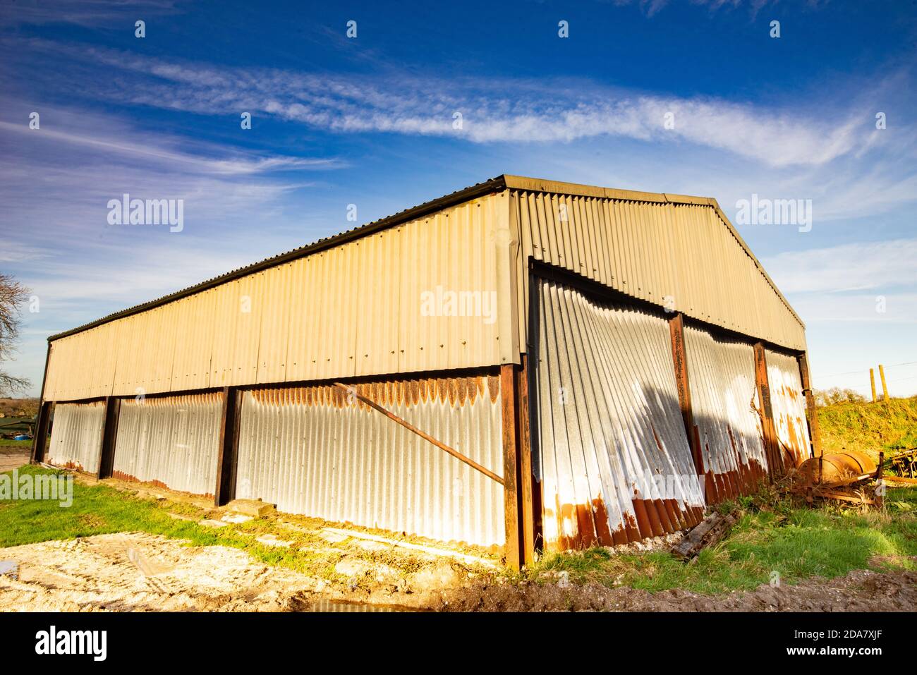 Corrugated barn with rust and damage in Rackham, West Sussex, England ...