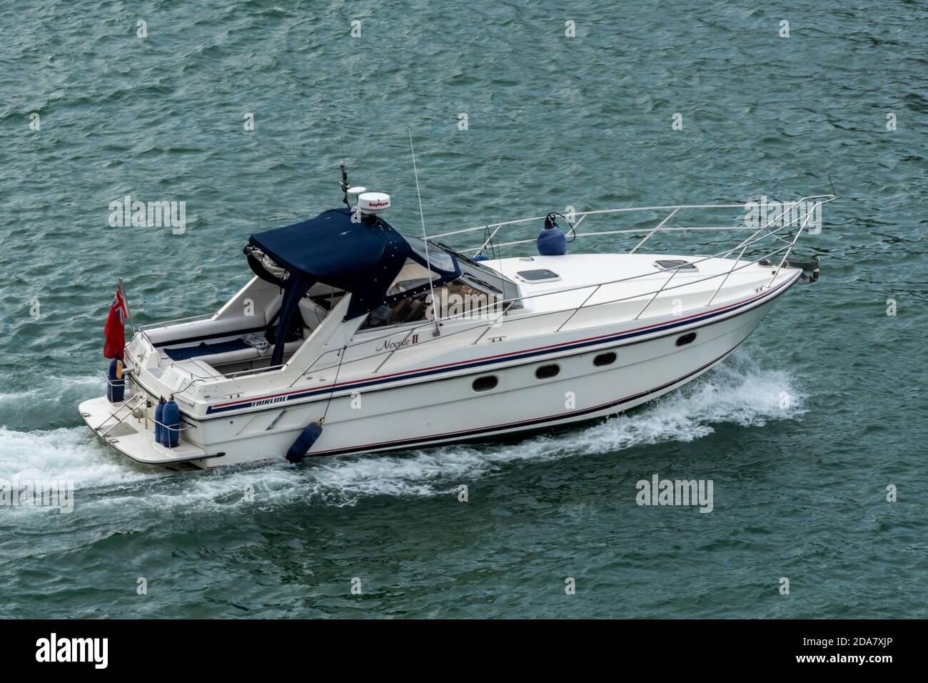 a large motorboat or luxury motor launch cruising in the solent with ...