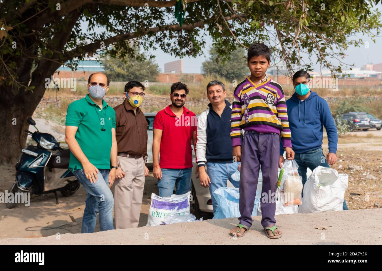 Group of young people of NGO in India distributing food to poor ...