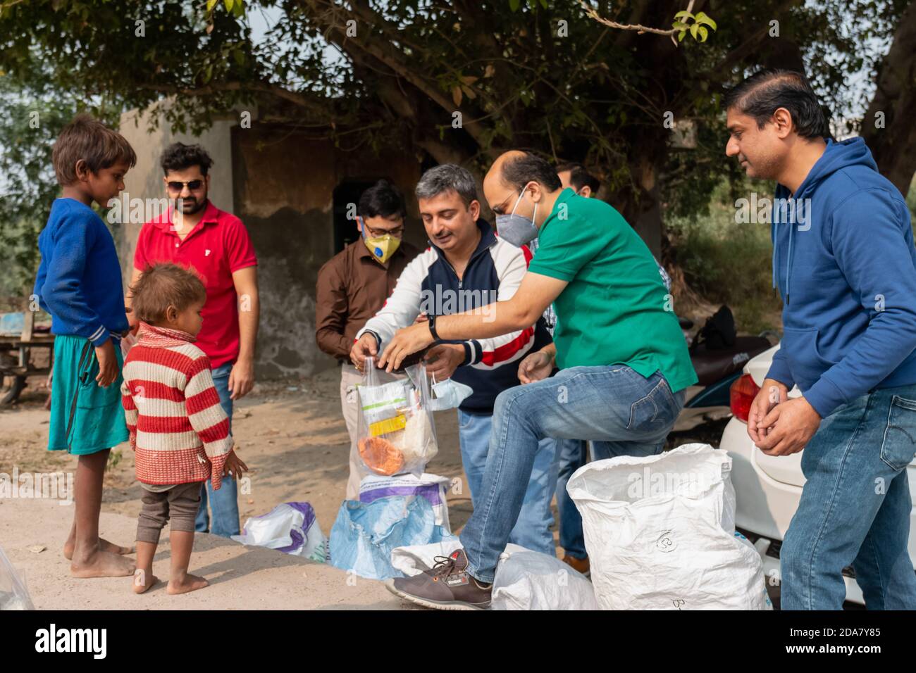 Group of young people of NGO in India distributing food to poor ...