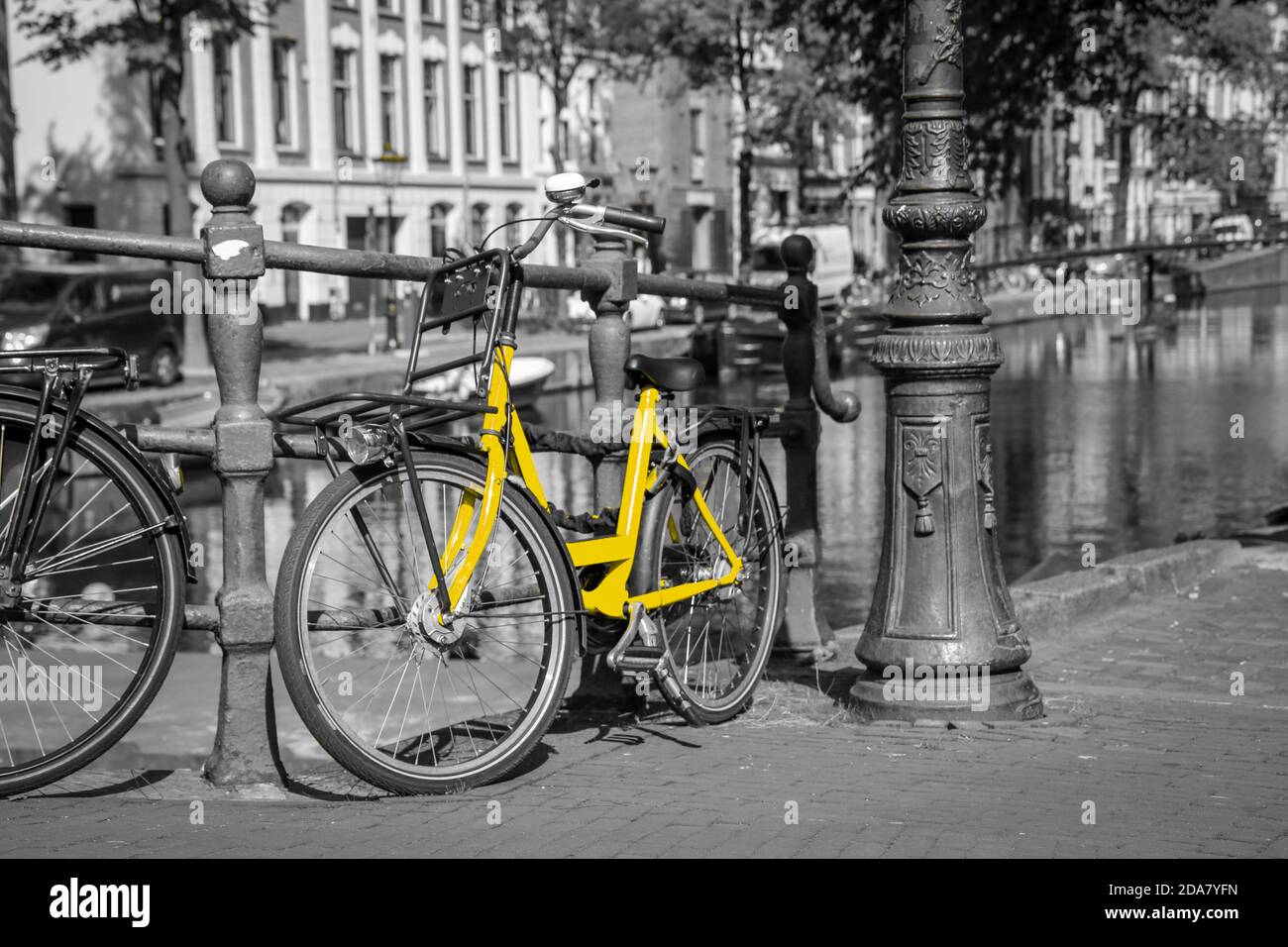 A fresh yellow bike on the streets of Amsterdam. Symbol for clean and ...