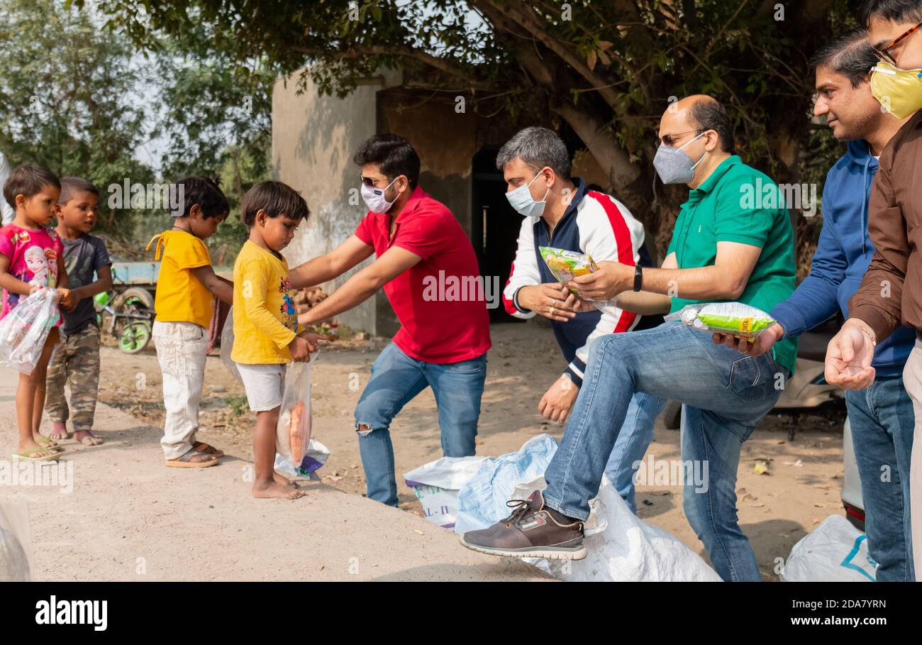 Group of young people of NGO in India distributing food to poor ...