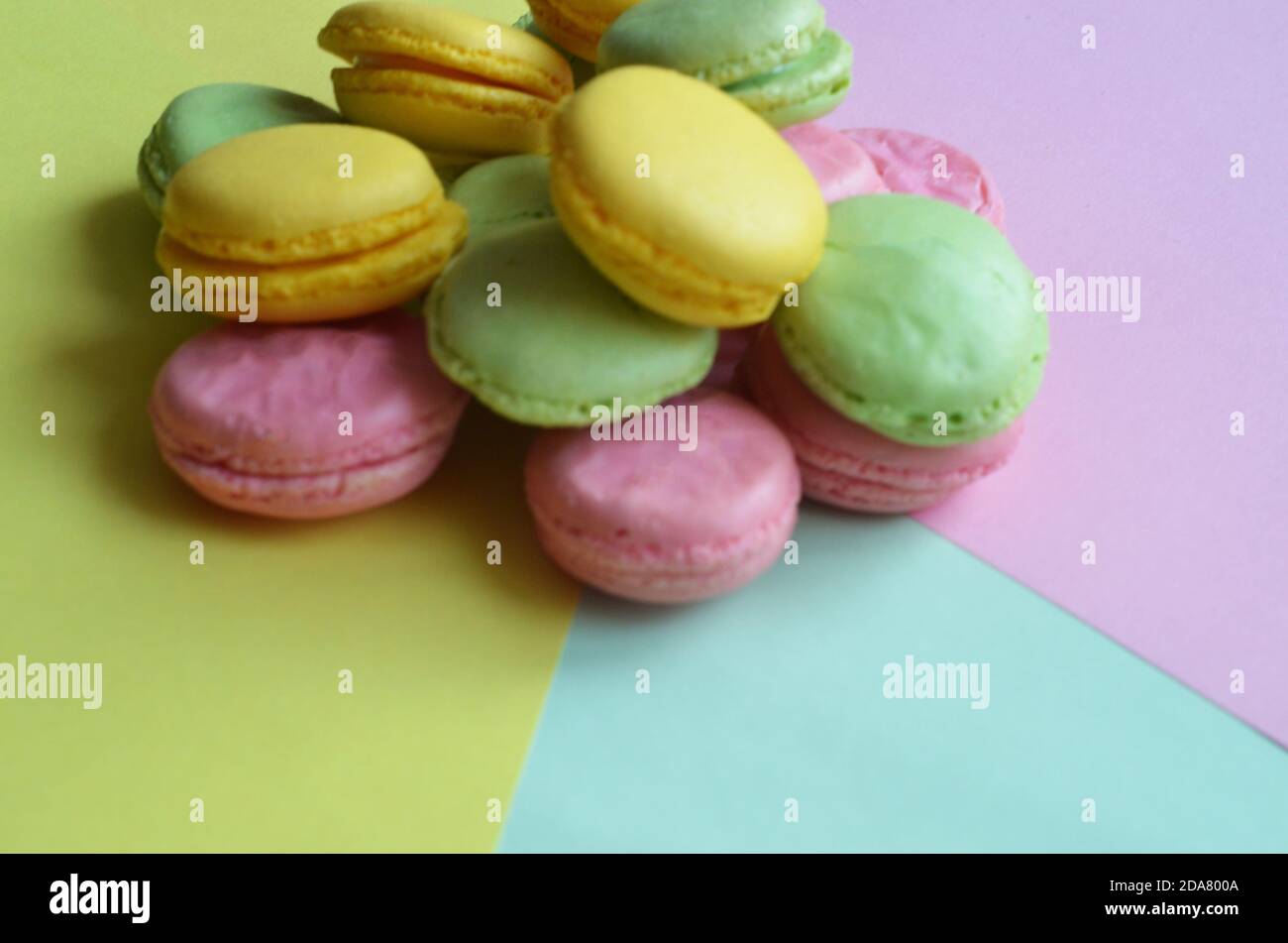 Mixed of colorful macaroni or pasta cake on a yellow pink blue ...