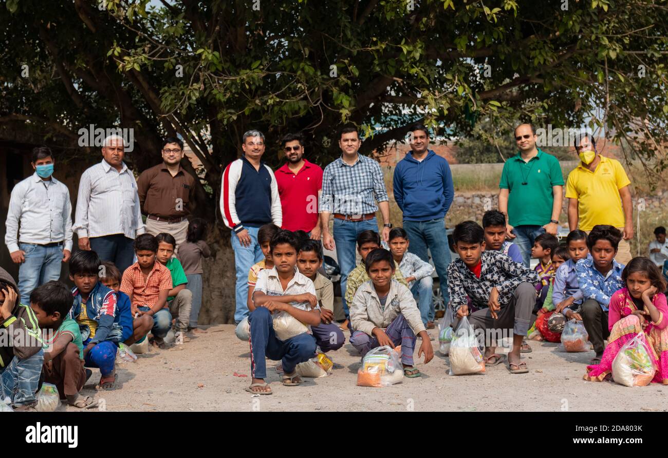 Group of young people of NGO in India distributing food to poor ...