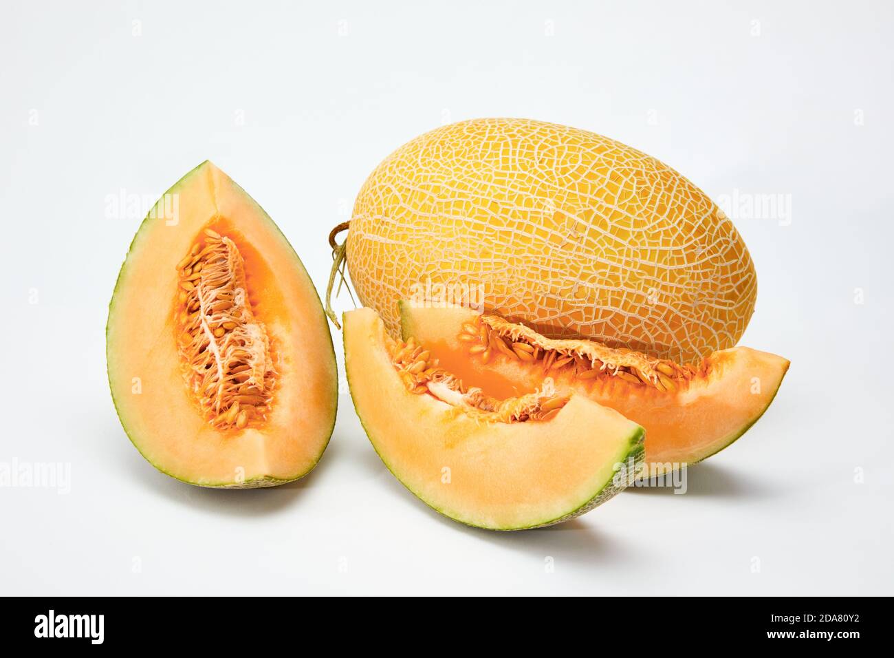 Fresh melon and some slices of melon on a white surface Stock Photo - Alamy