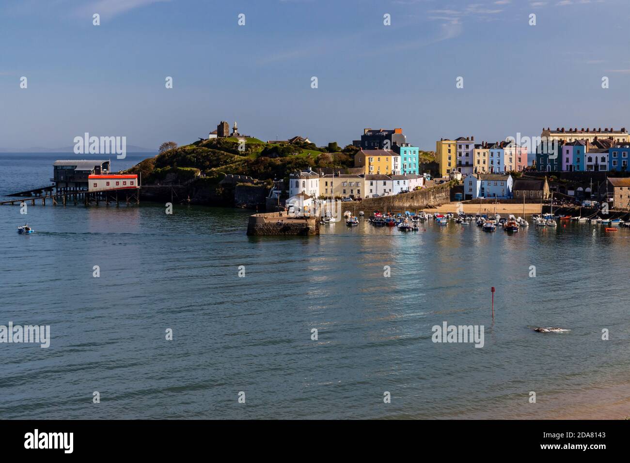 Colourful buildings and boats in the harbor of the Welsh seaside town ...