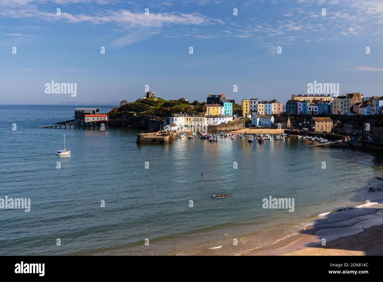 Colourful buildings and boats in the harbor of the Welsh seaside town ...