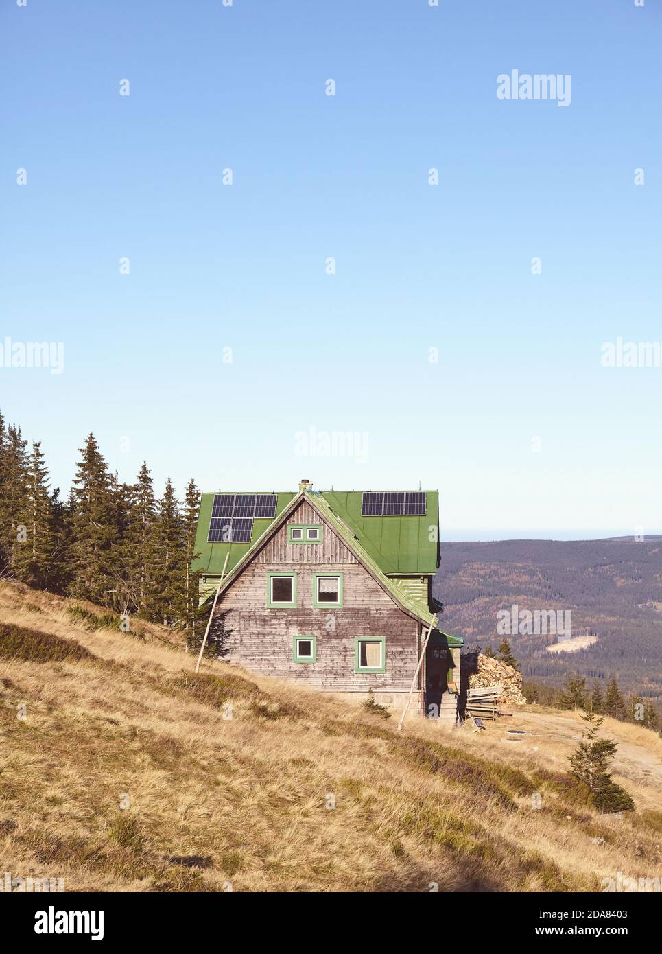 Retro toned picture of mountain hut with solar panels on roof Stock ...