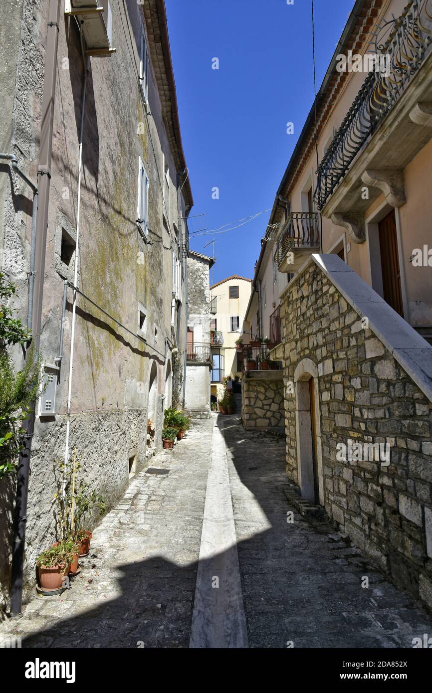 A narrow street among the old houses of Santa Croce del Sannio, a ...