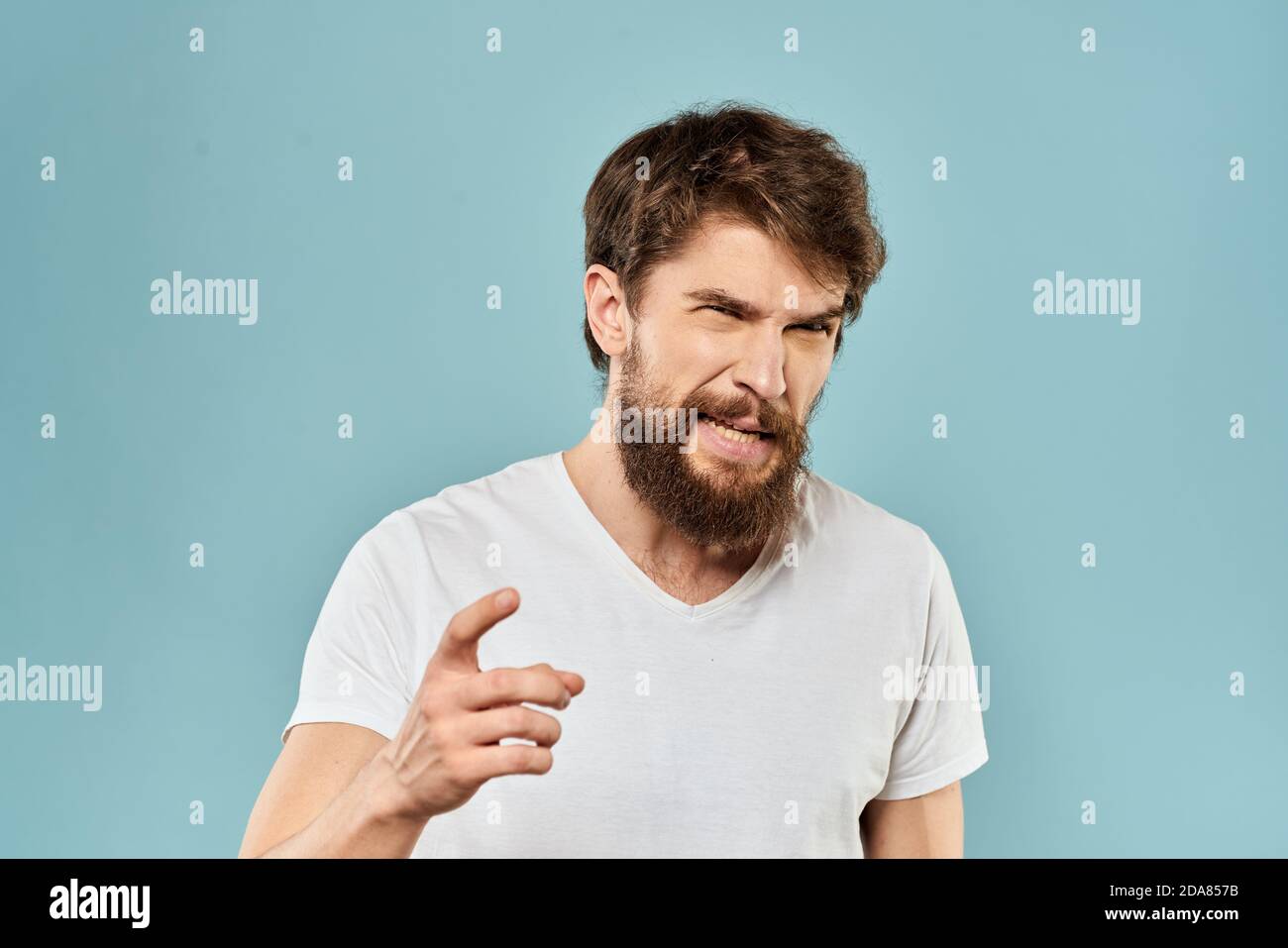 Man gestures with his hands emotions displeasure white t-shirt blue ...