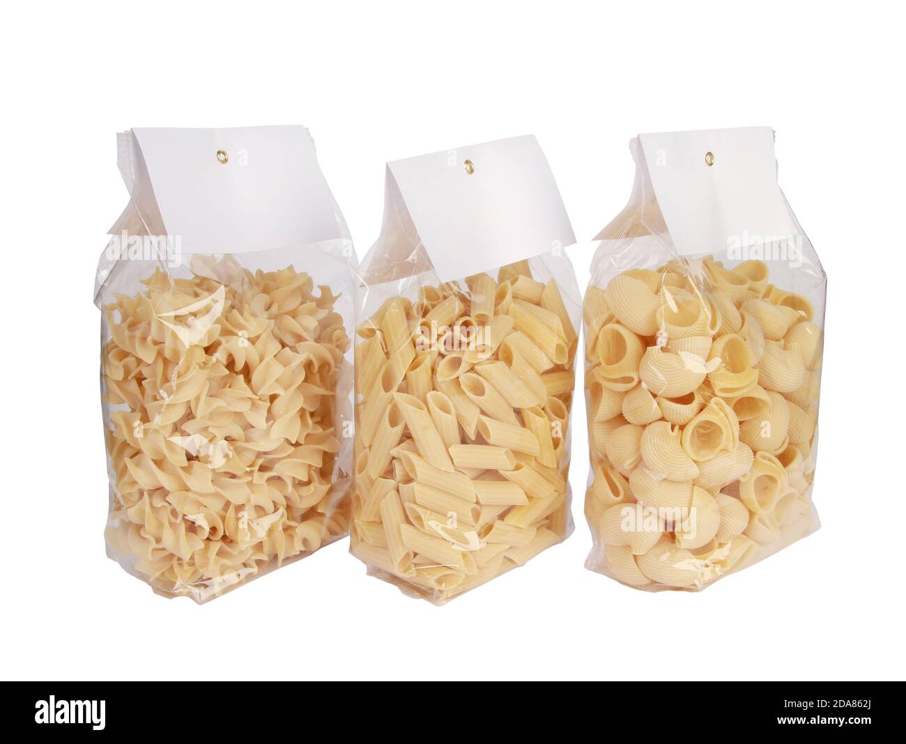 Three clear packages of various pasta isolated on a white background ...