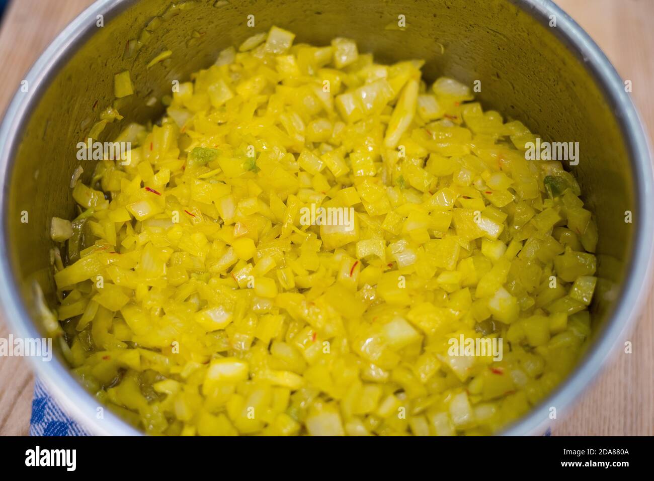 Looking into large pot with almost translucent onion cubes Stock Photo ...