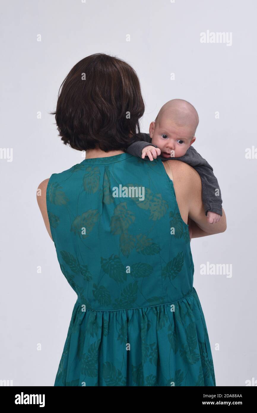 rear view of a mother with her baby on white background Stock Photo - Alamy