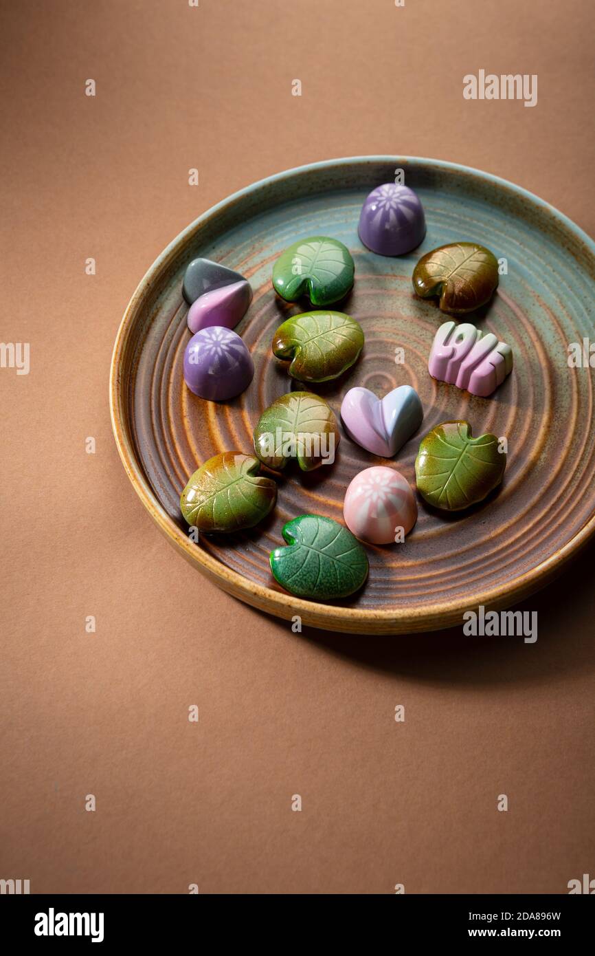 Set of chocolate candies on plate Stock Photo - Alamy