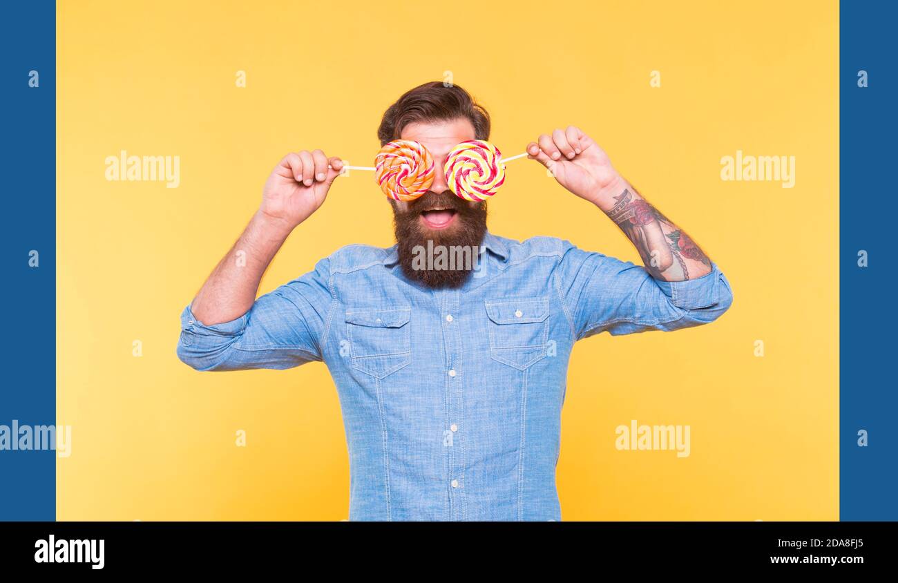 Funny bearded man hold sugar glasses rainbow swirl candy lollipops for ...