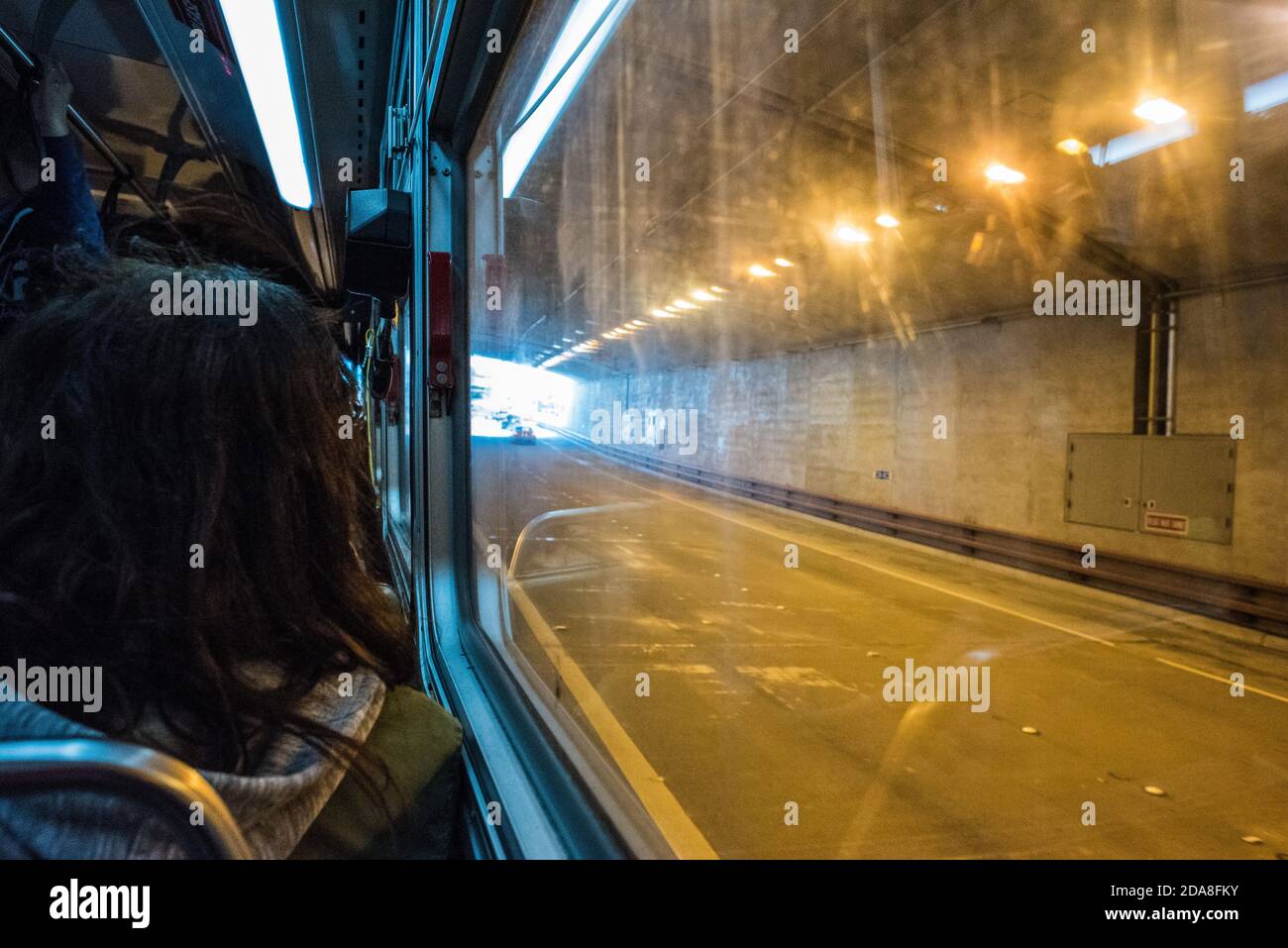 Girl looking out of the bus window Stock Photo - Alamy