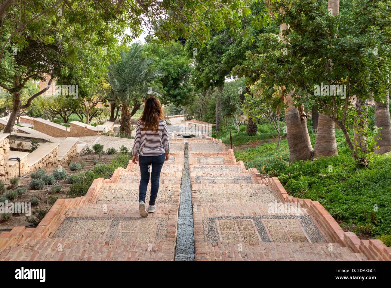 Spain; Nov 2020: Person walking at Arab gardens inside an old ...