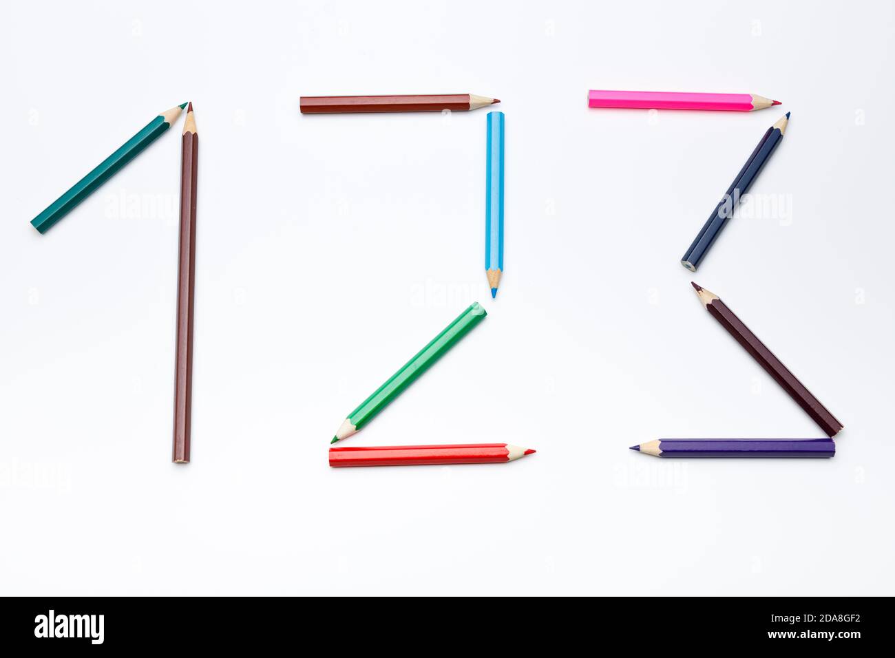 Numbers 1 2 3 made of small color pencils on white uniform background ...