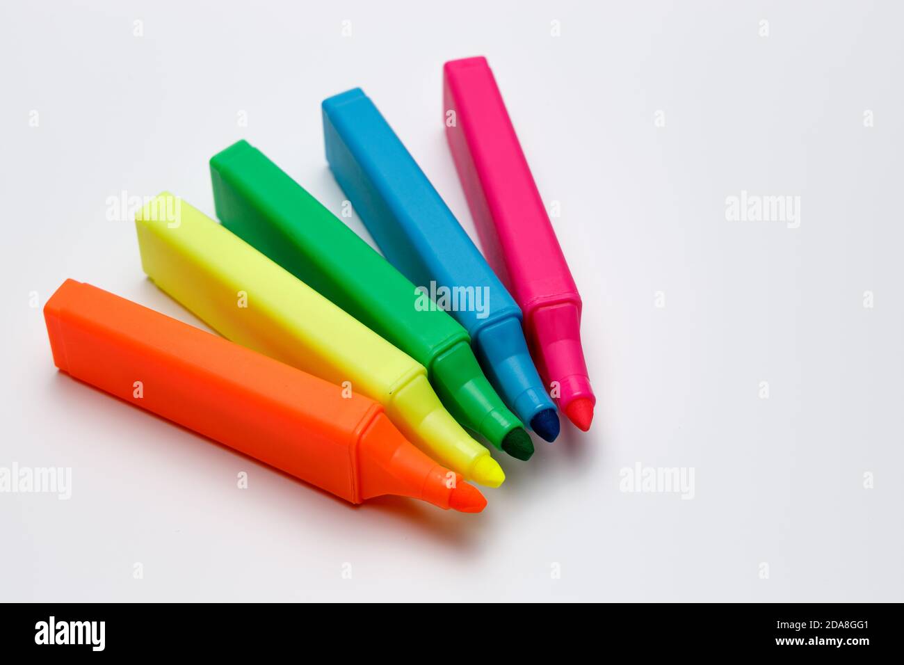 Top view of highlighter pens on white uniform background, neon colors ...