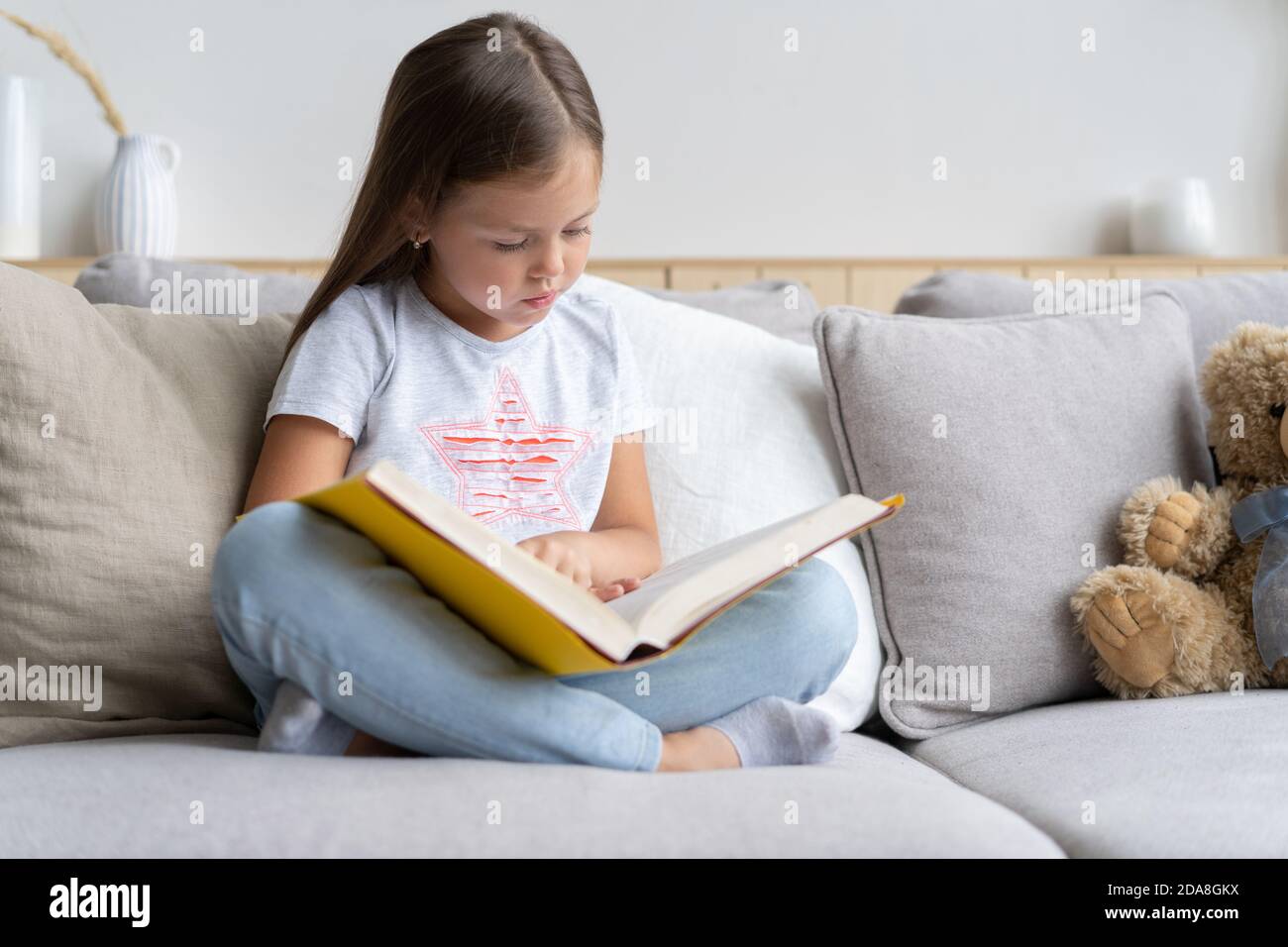 Young girl reading book at home. Distance education, home education ...