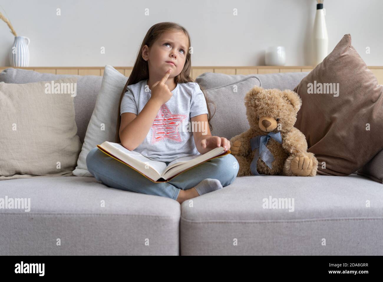 Young girl reading book at home. Distance education, home education ...