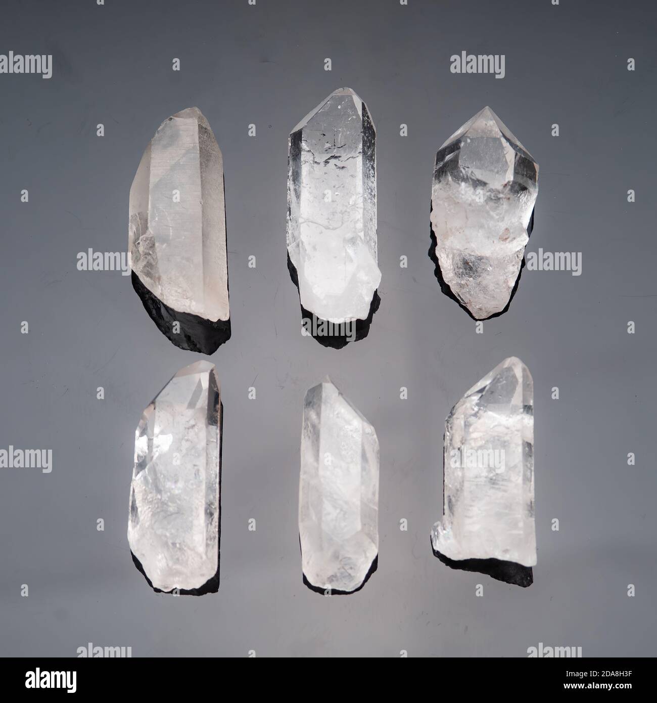 Crystals of natural quartz on a gray background Stock Photo - Alamy