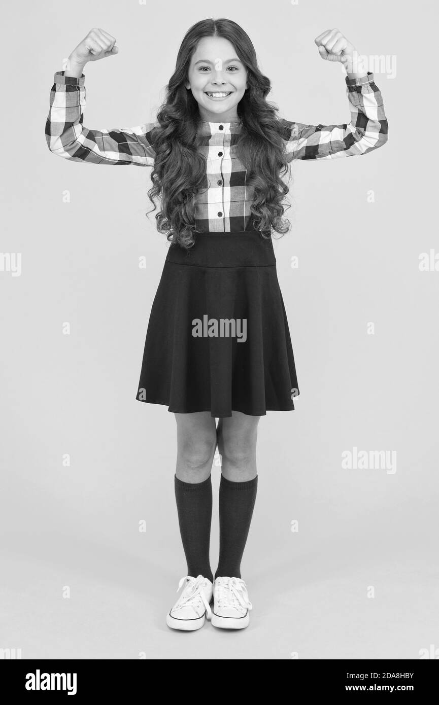 Mentally strong. Feeling strong. Child cute smiling girl show biceps ...