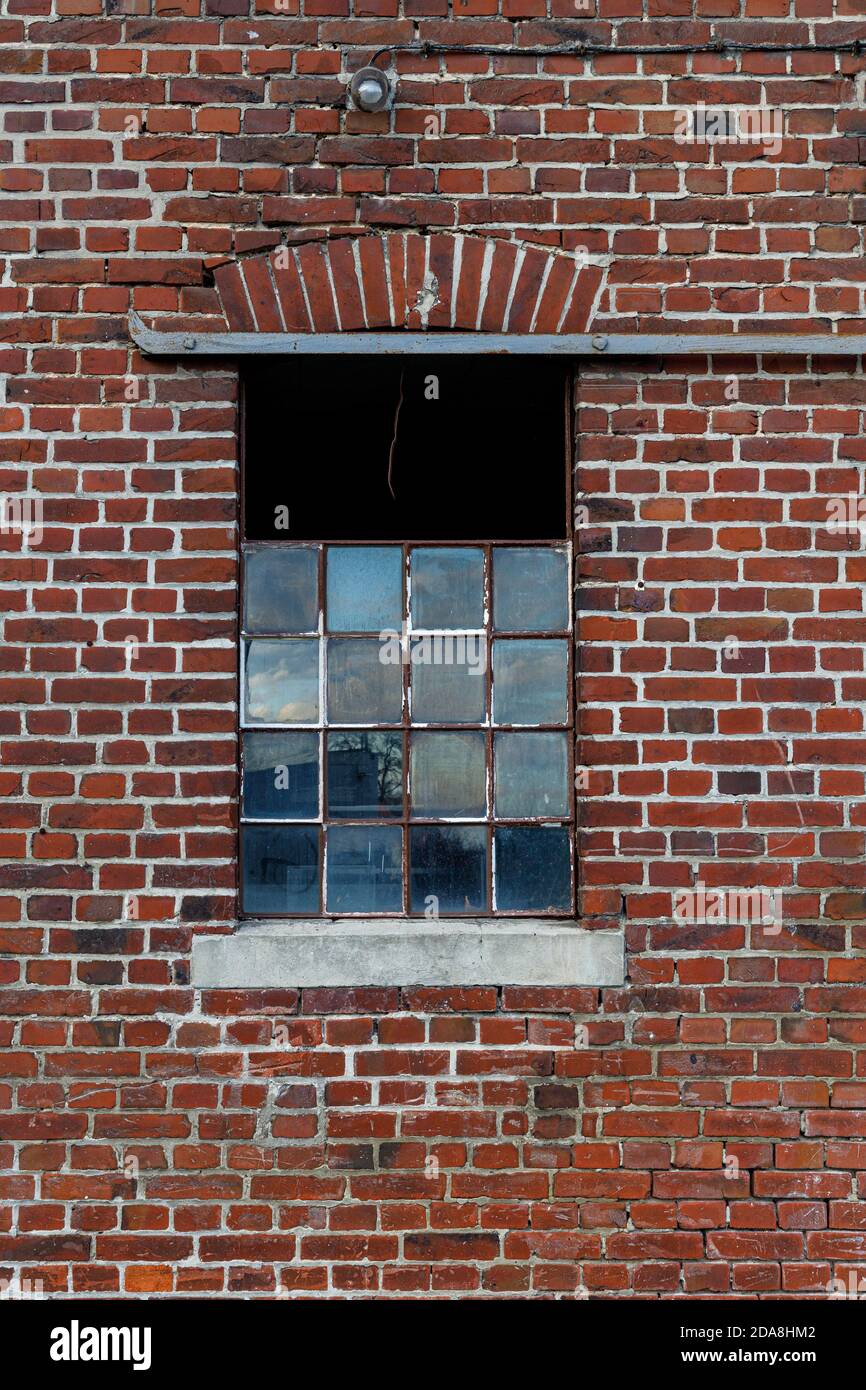 Broken damaged industrial window with a rusted metal frame, some parts ...
