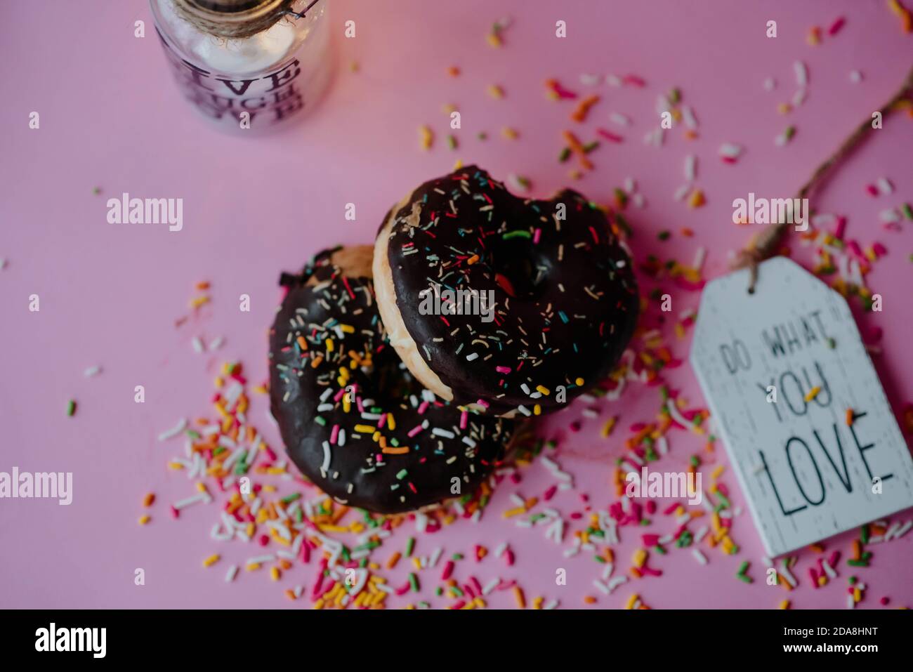 Closeup shot of delicious chocolate donuts with sprinkles and love ...