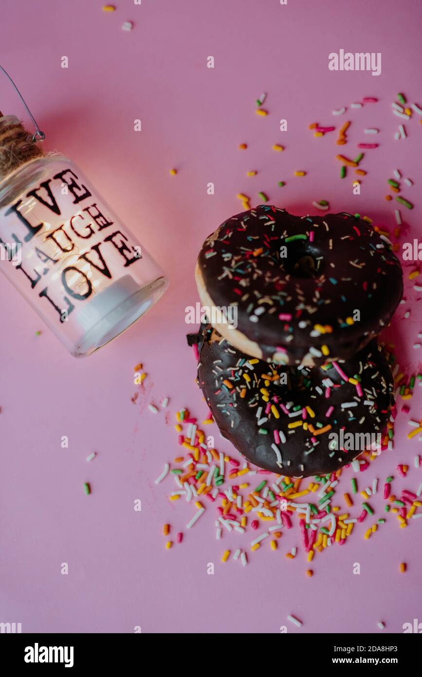 Closeup shot of delicious chocolate donuts with sprinkles and love ...