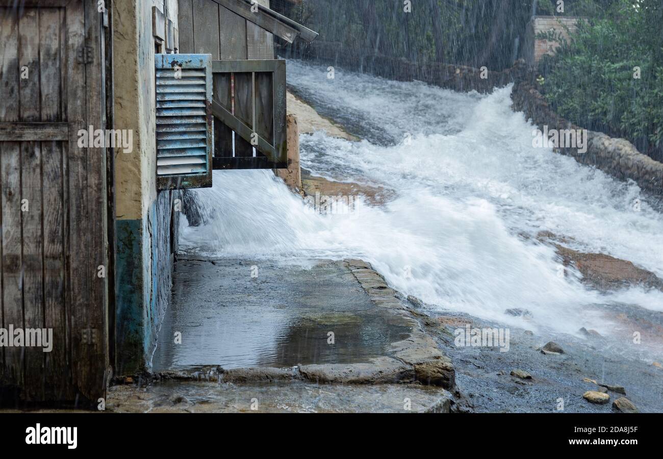 Scene showing flooding on a street with buildings Stock Photo - Alamy