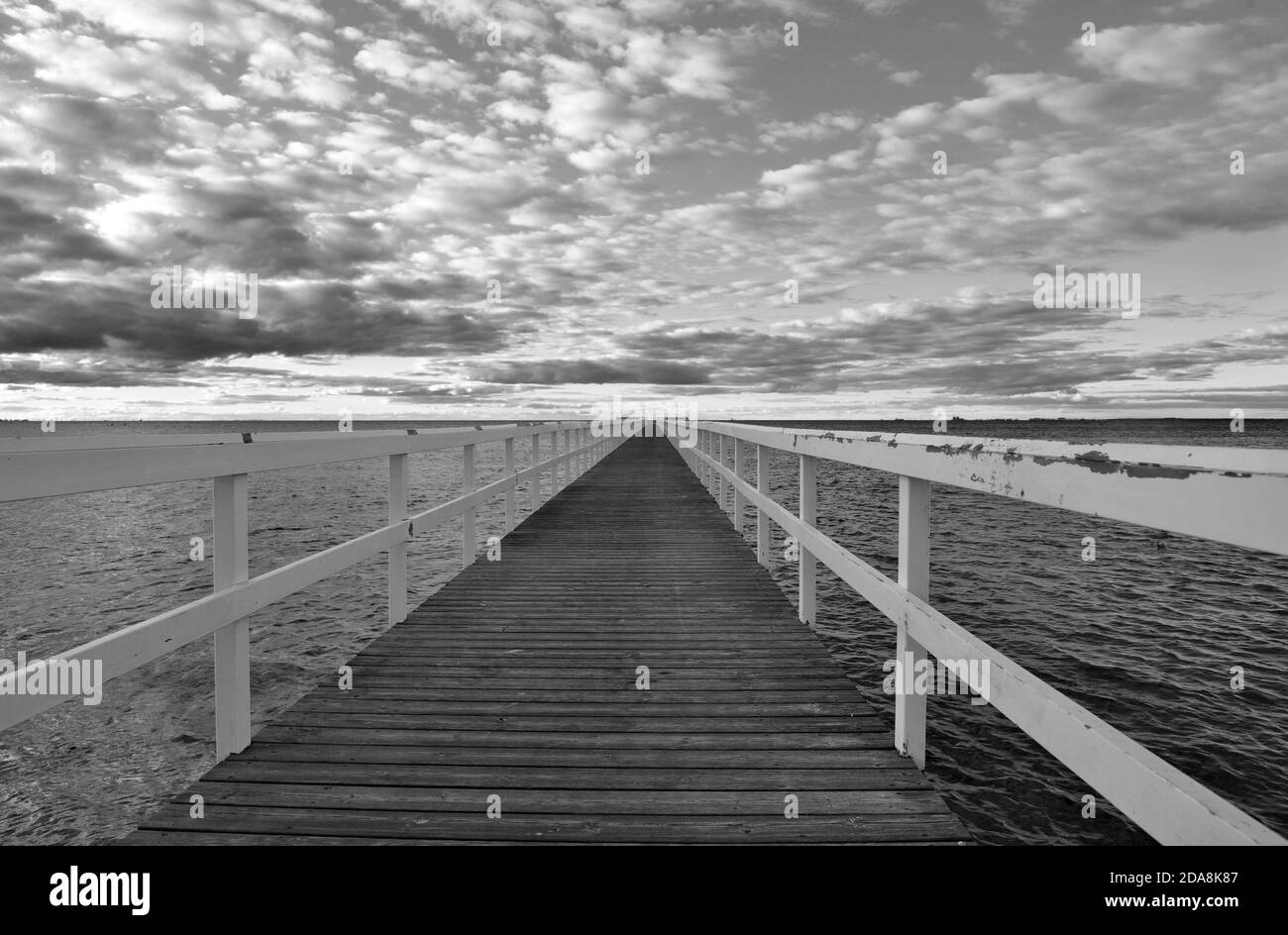 Clouds scurry across the sky in this black and white photo taken in ...