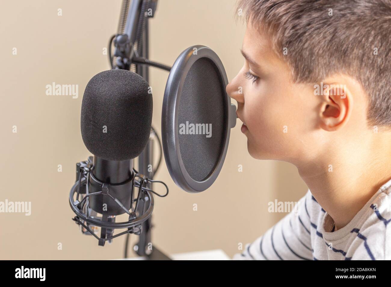Kid with laptop computer talking into microphone. Techology, online ...